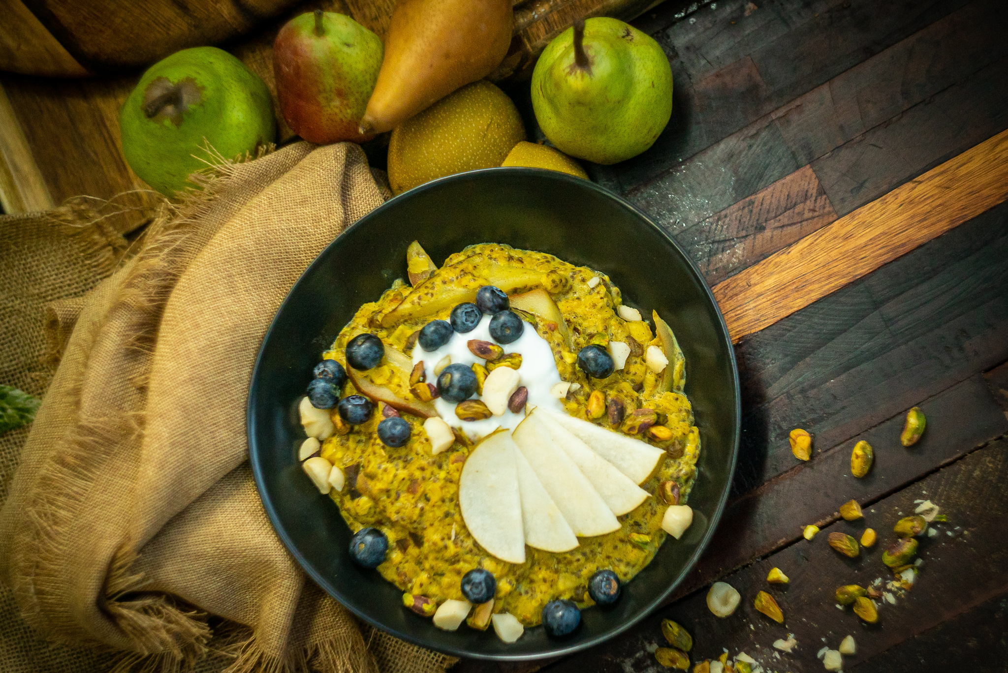 Turmeric pear porridge with macadamias and pistachios